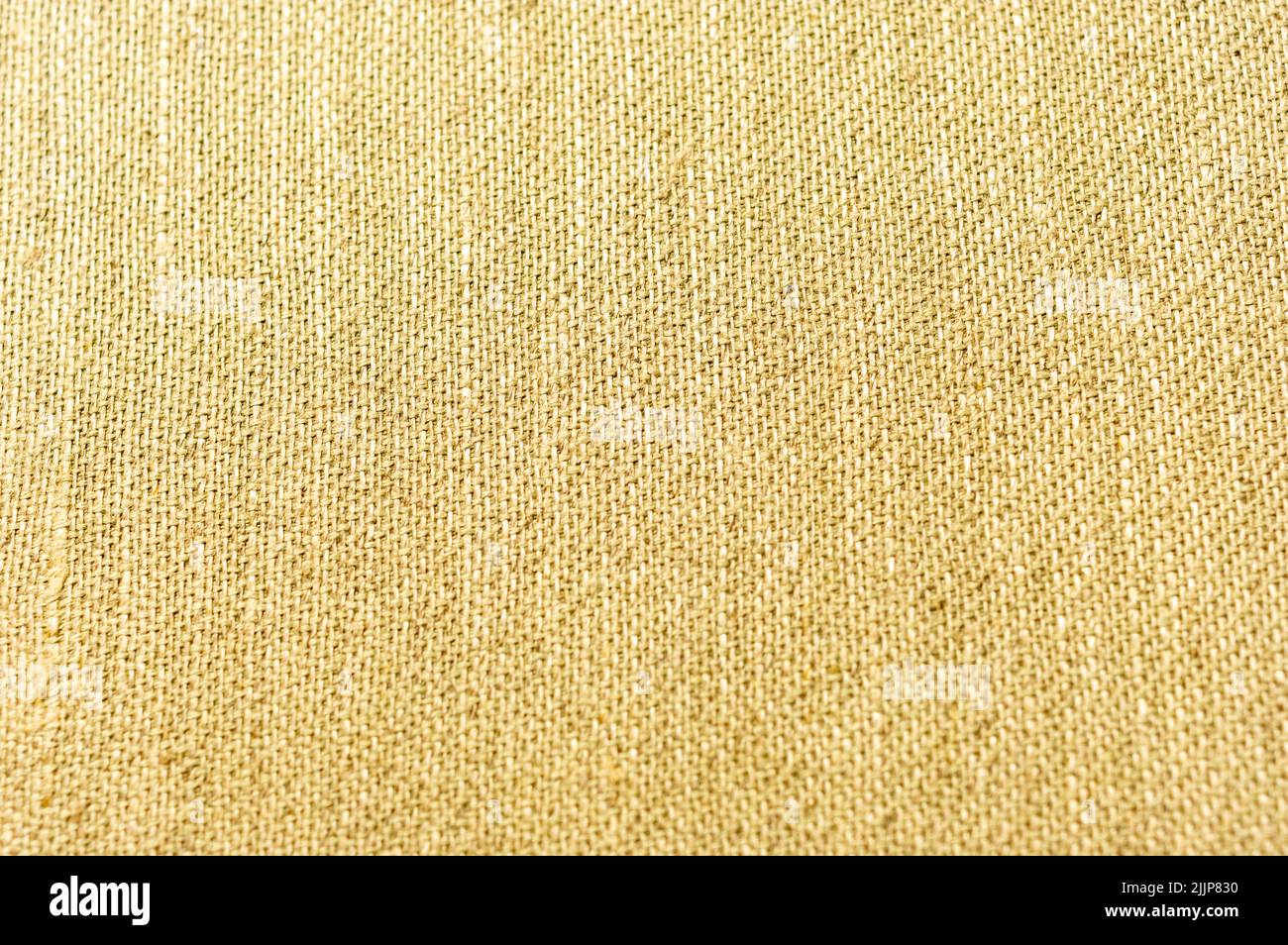 A detailed closeup of an old, brown linen cloth for creative background ...
