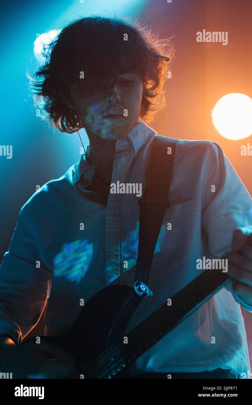 The Lathums band performing live at a concert, focus on lead guitarist ...