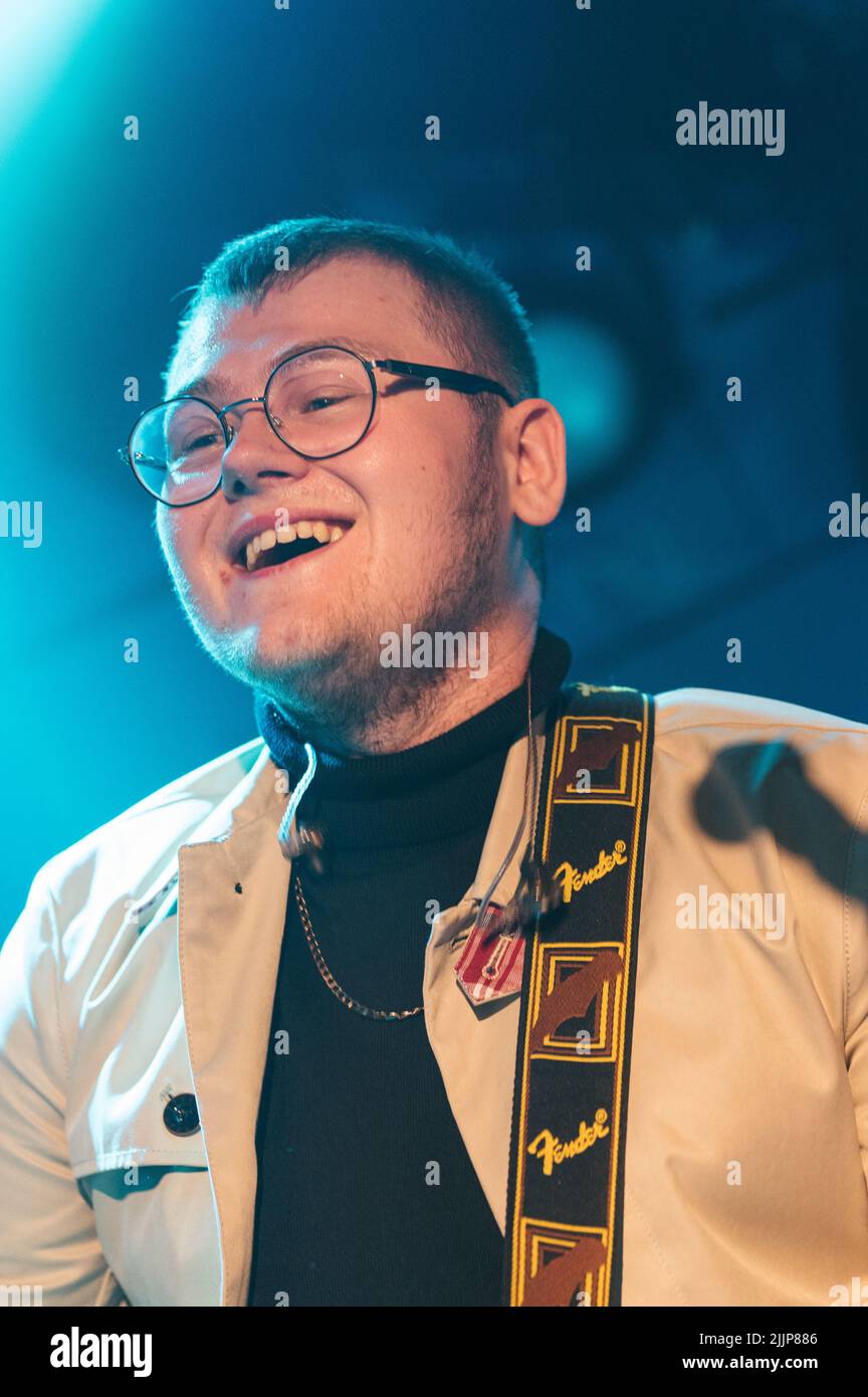 The Lathums band performing live at a concert, focus on lead guitarist ...