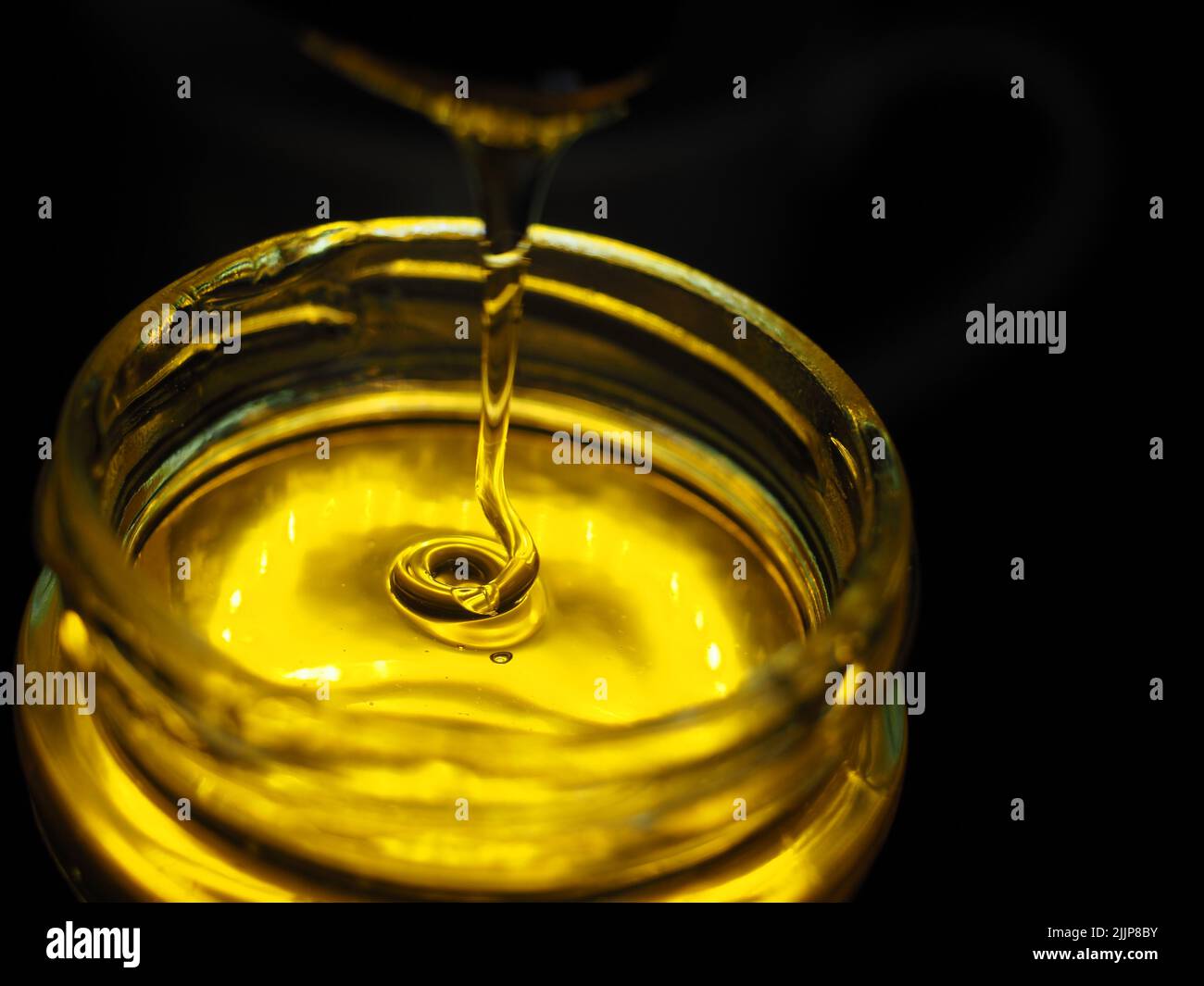 Golden yellow fresh honey flowing hi-res stock photography and images ...
