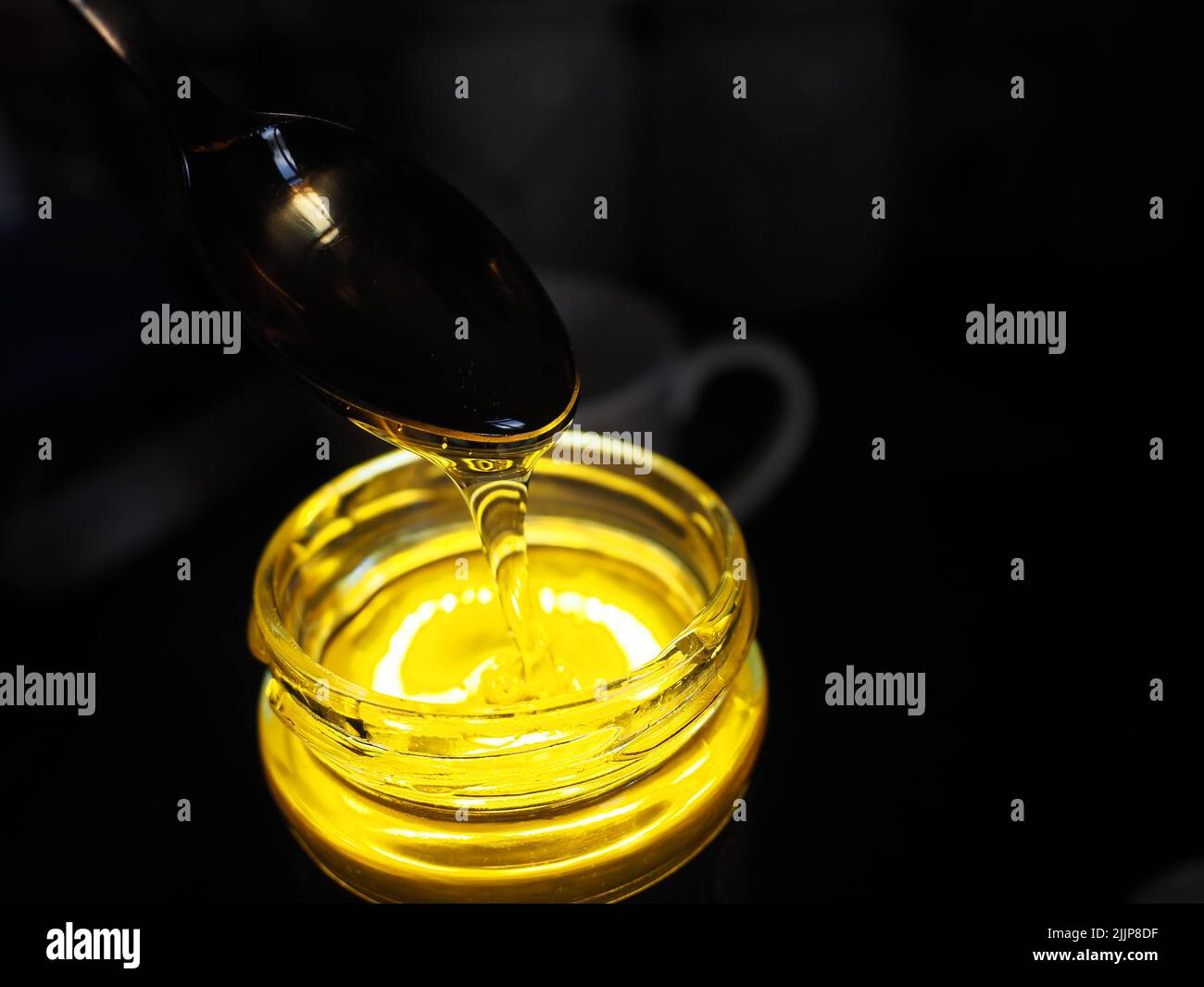 The close-up beautiful shot of liquid golden honey Stock Photo - Alamy