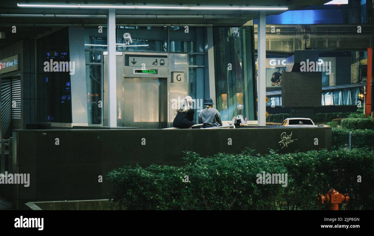 The people outside the entrance door of the MRT train station in Kuala ...