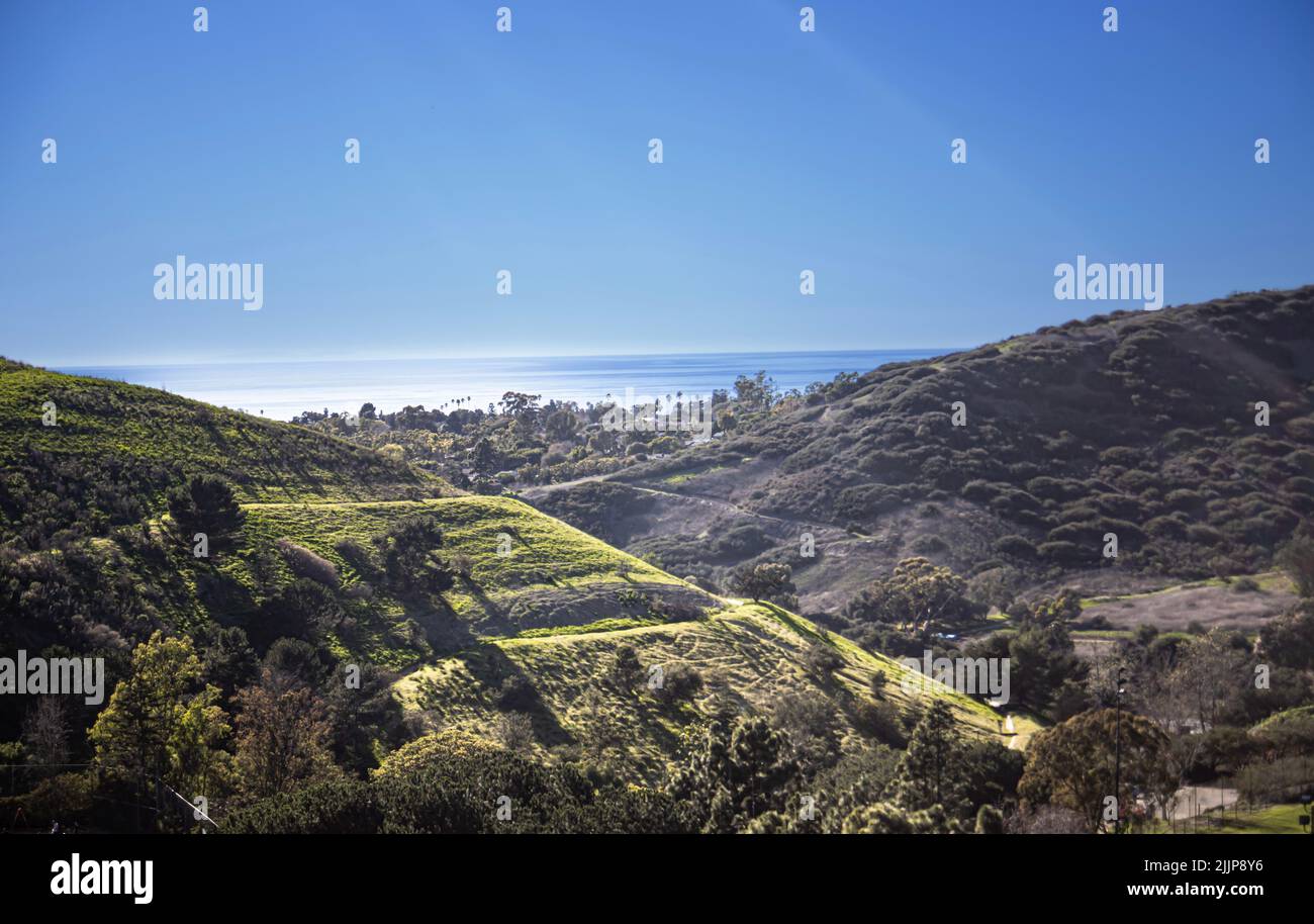 A breathtaking landscape of hills with lush greenery in the background ...