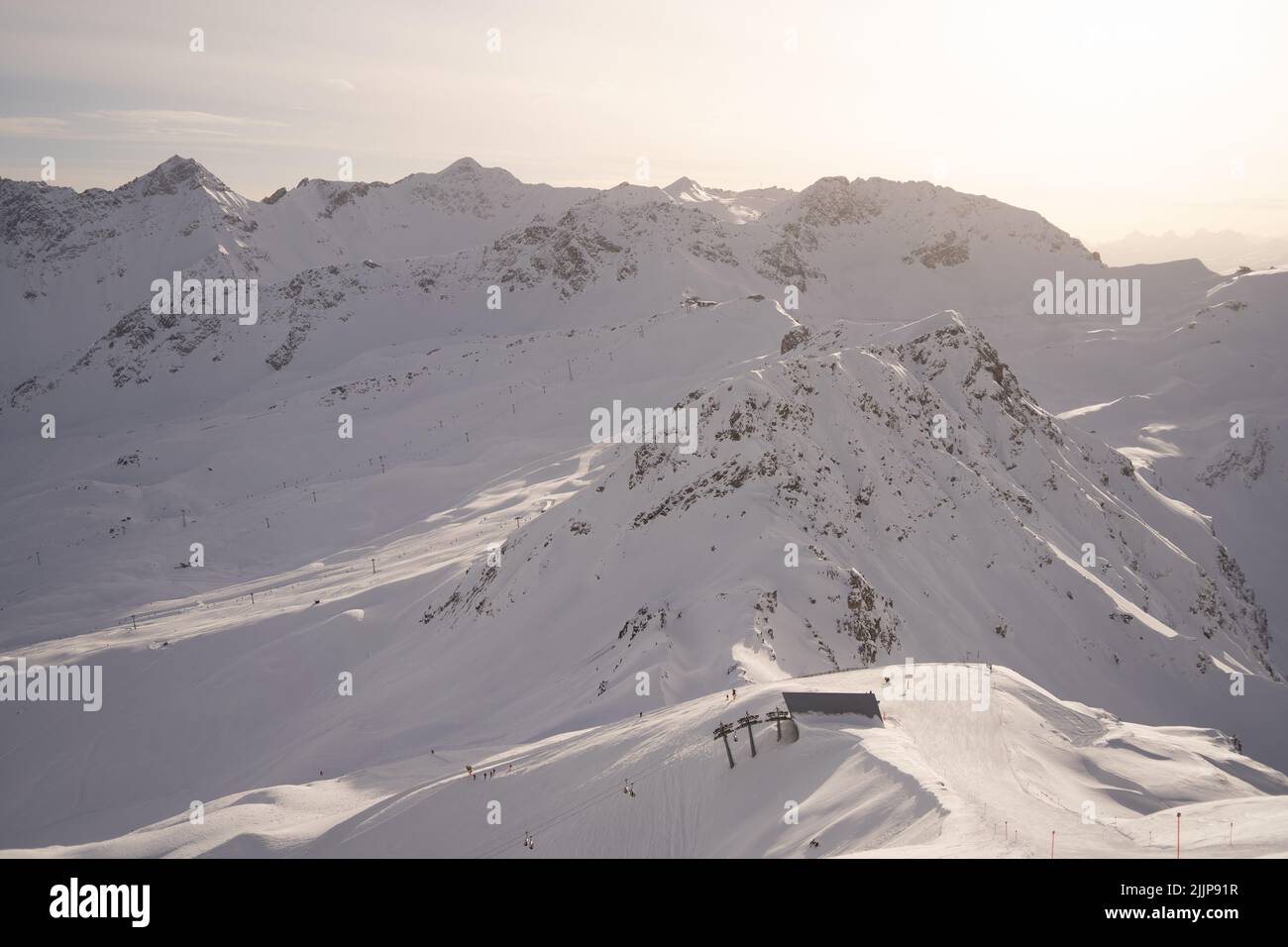 A view of snow covered mountains under shining sun Stock Photo - Alamy