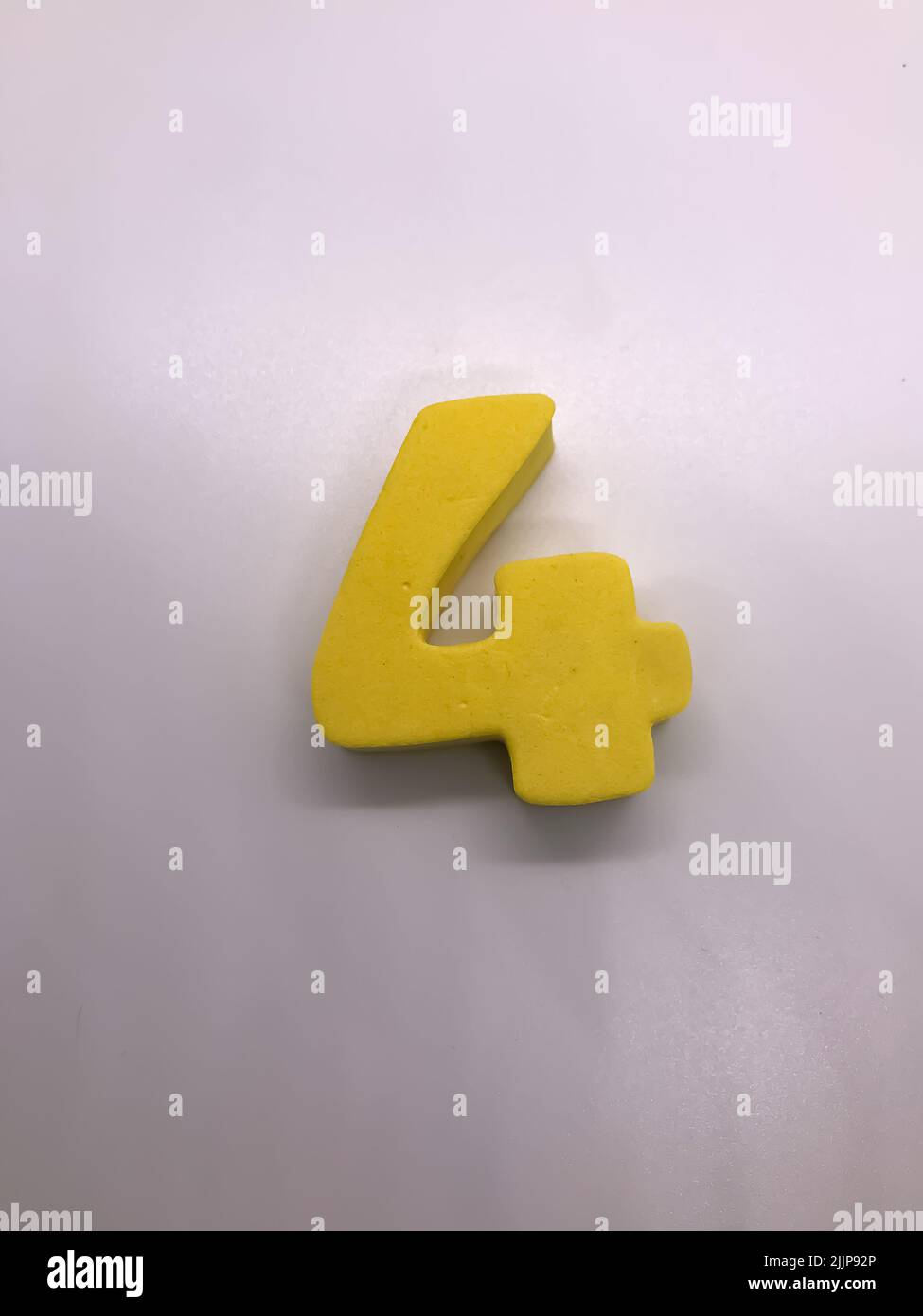 A yellow number 4 isolated on white background Stock Photo - Alamy
