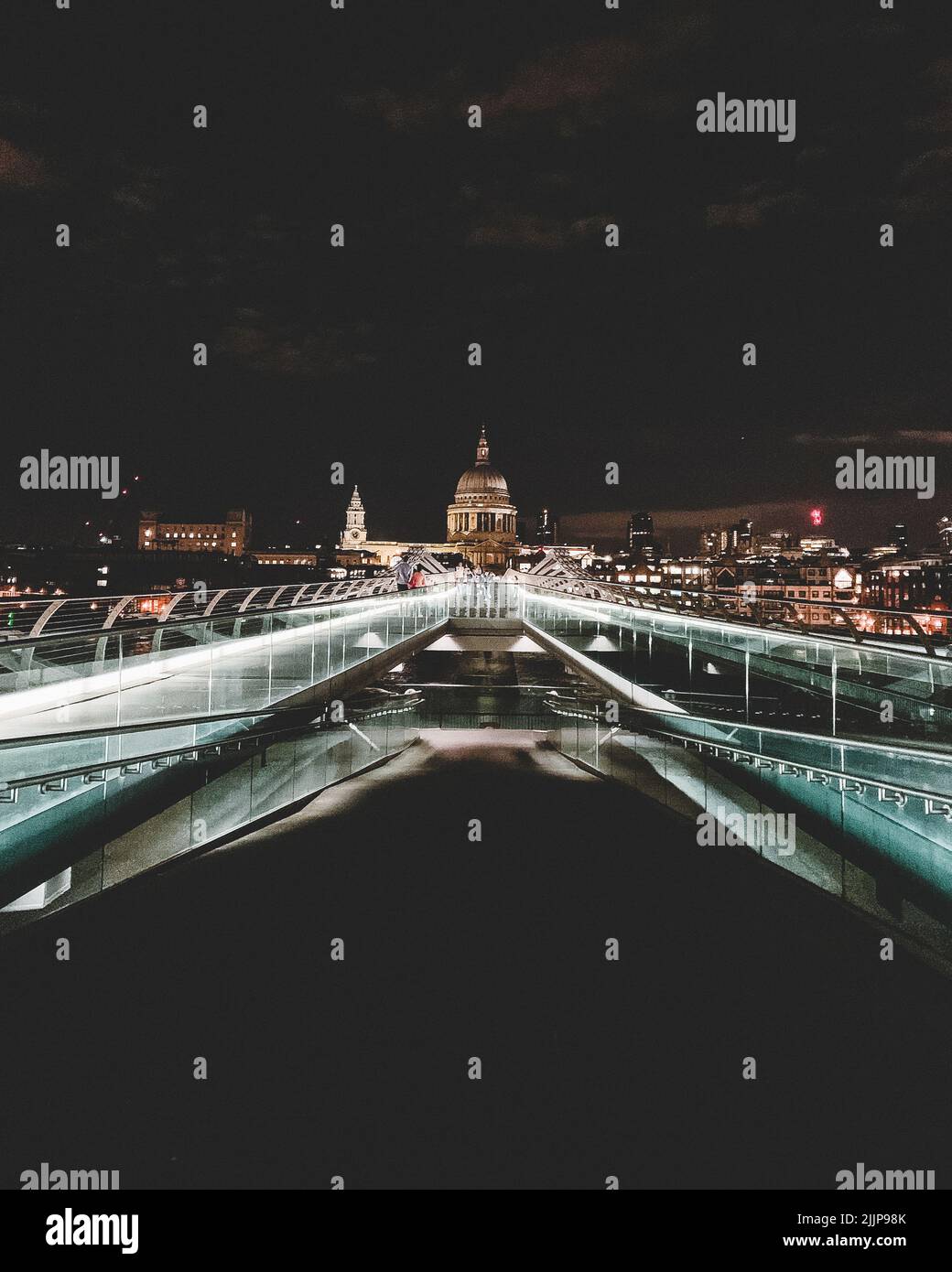 A mesmerizing view of the illuminated Millenium bridge with the ...