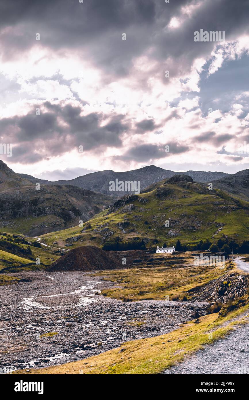 A vertical shot of Lake District National Park with house in foot of ...