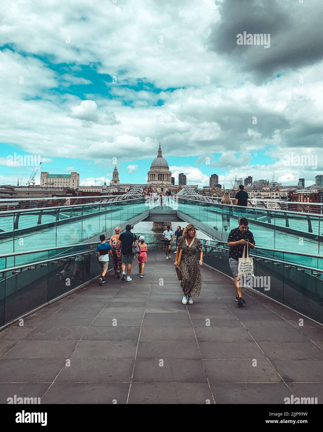 An aerial shot of people walking on the Millennium Bridge Stock Photo ...