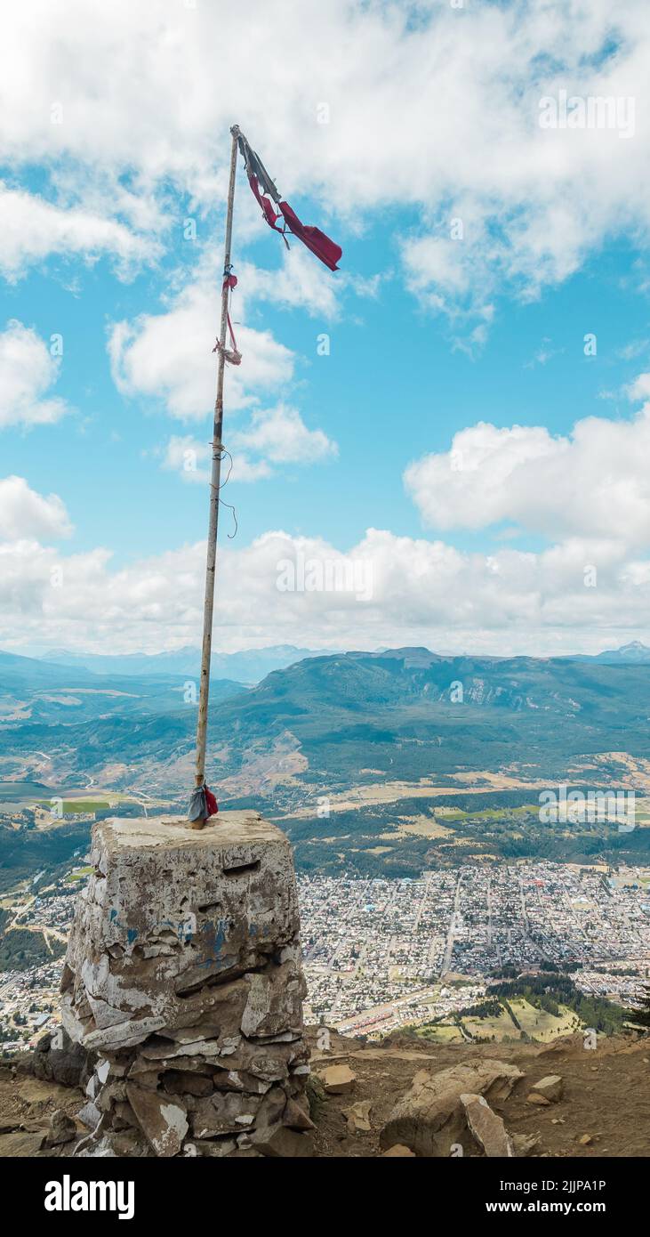 An aerial view of aged flag waving on Cerro Mackay crag with Chile ...