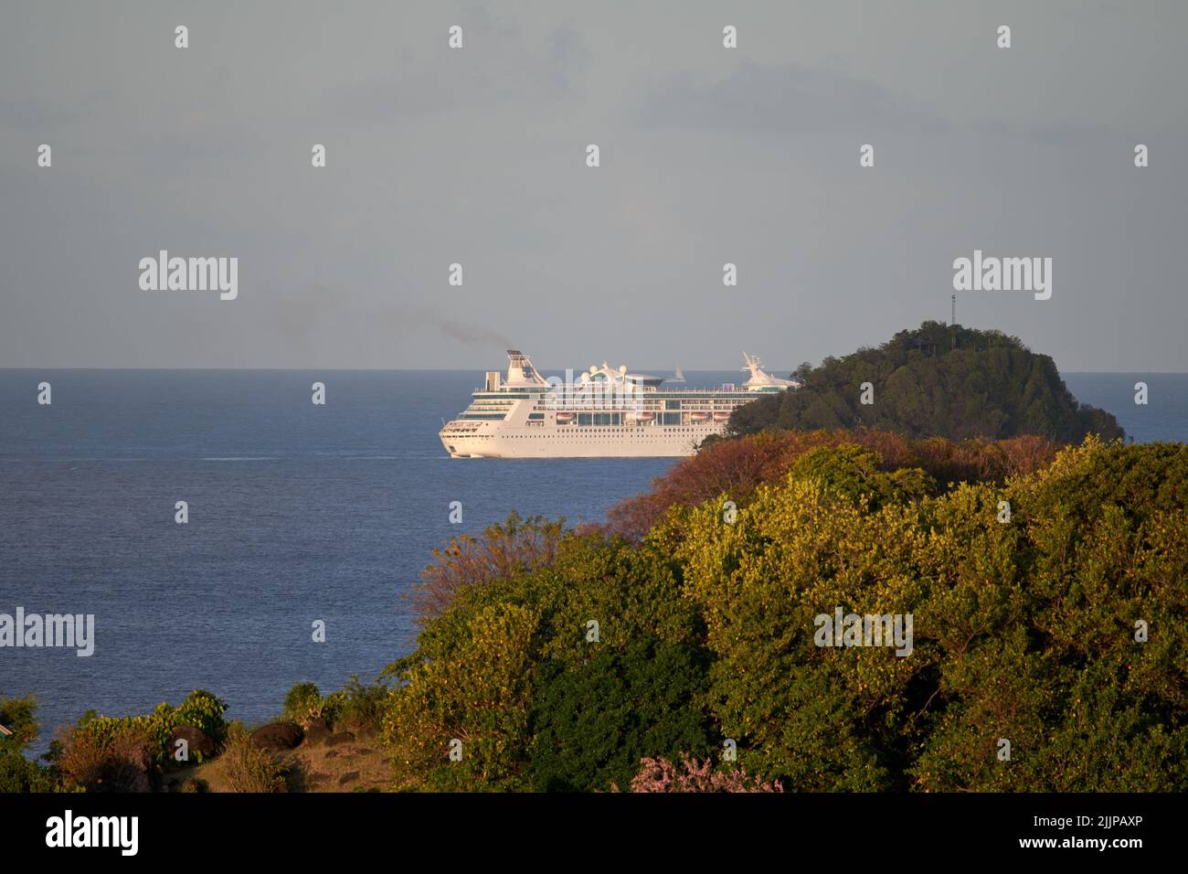 A beautiful view of trees and greenery on the seacoast with a ship ...