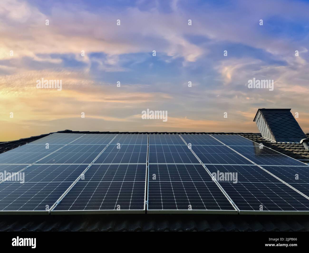 Solar panels producing clean energy on a roof of a residential house ...