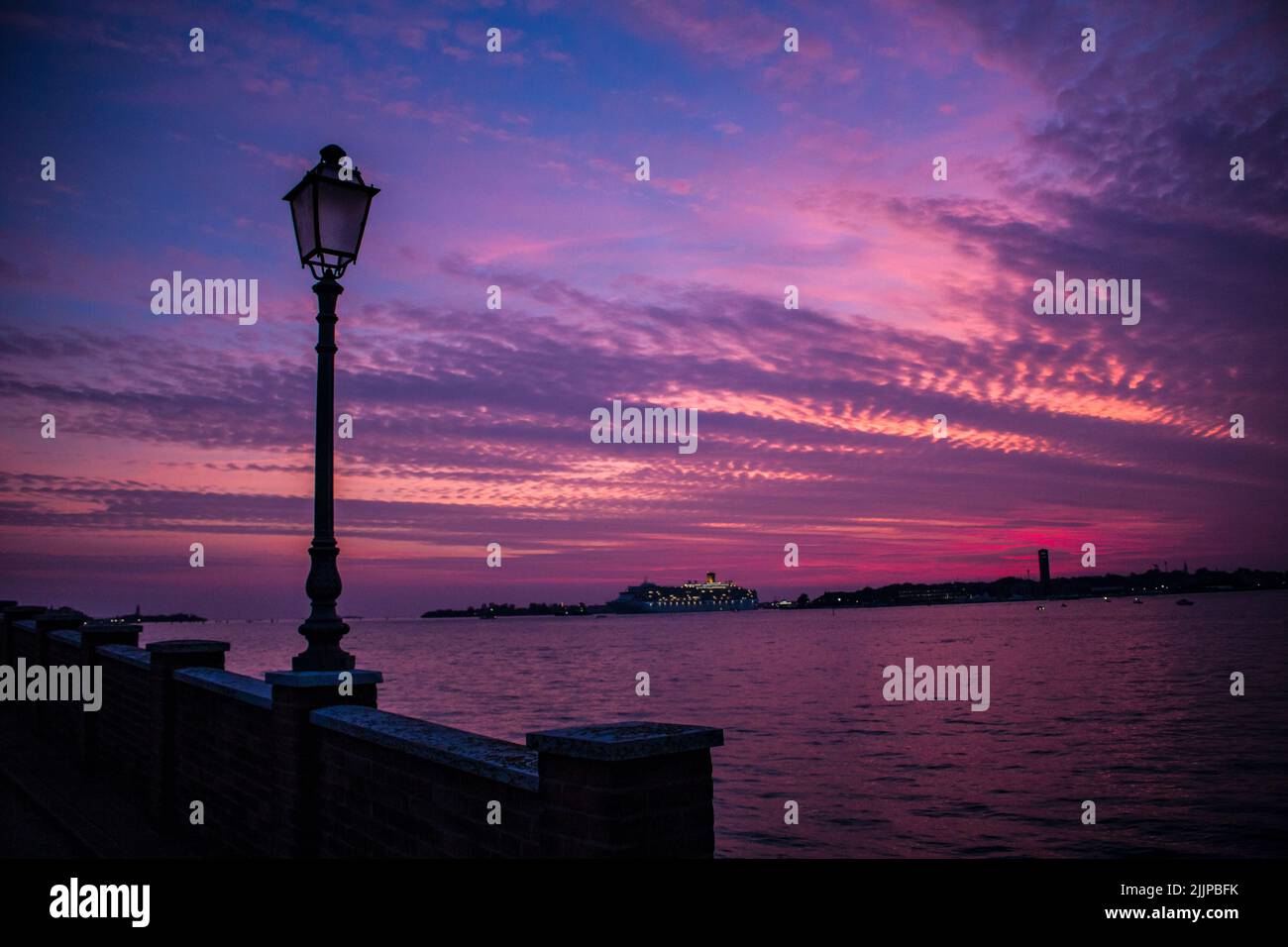 A beautiful pink and purple sunset shining over the waters in Venice ...