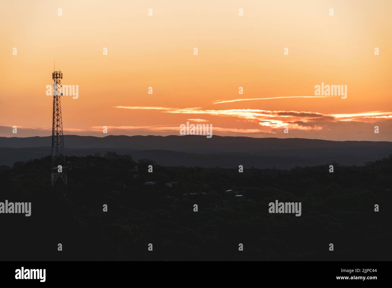 A beautiful landscape of a hill with a radio tower on the sunset Stock ...