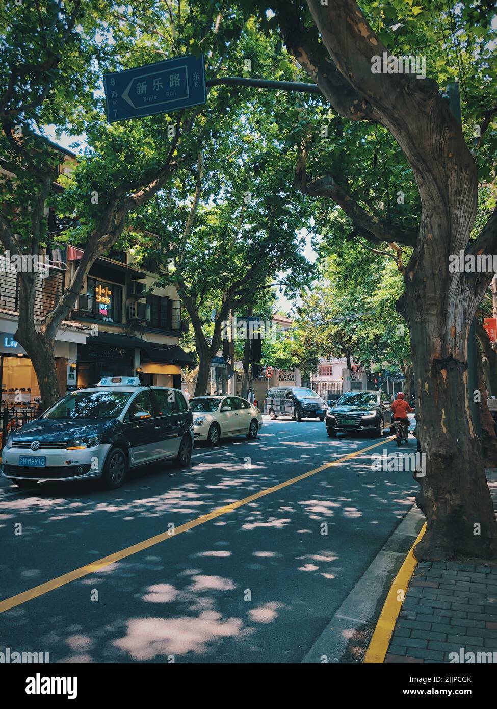 A closeup of a cars driving in Shanghai in the middle of summer Stock ...