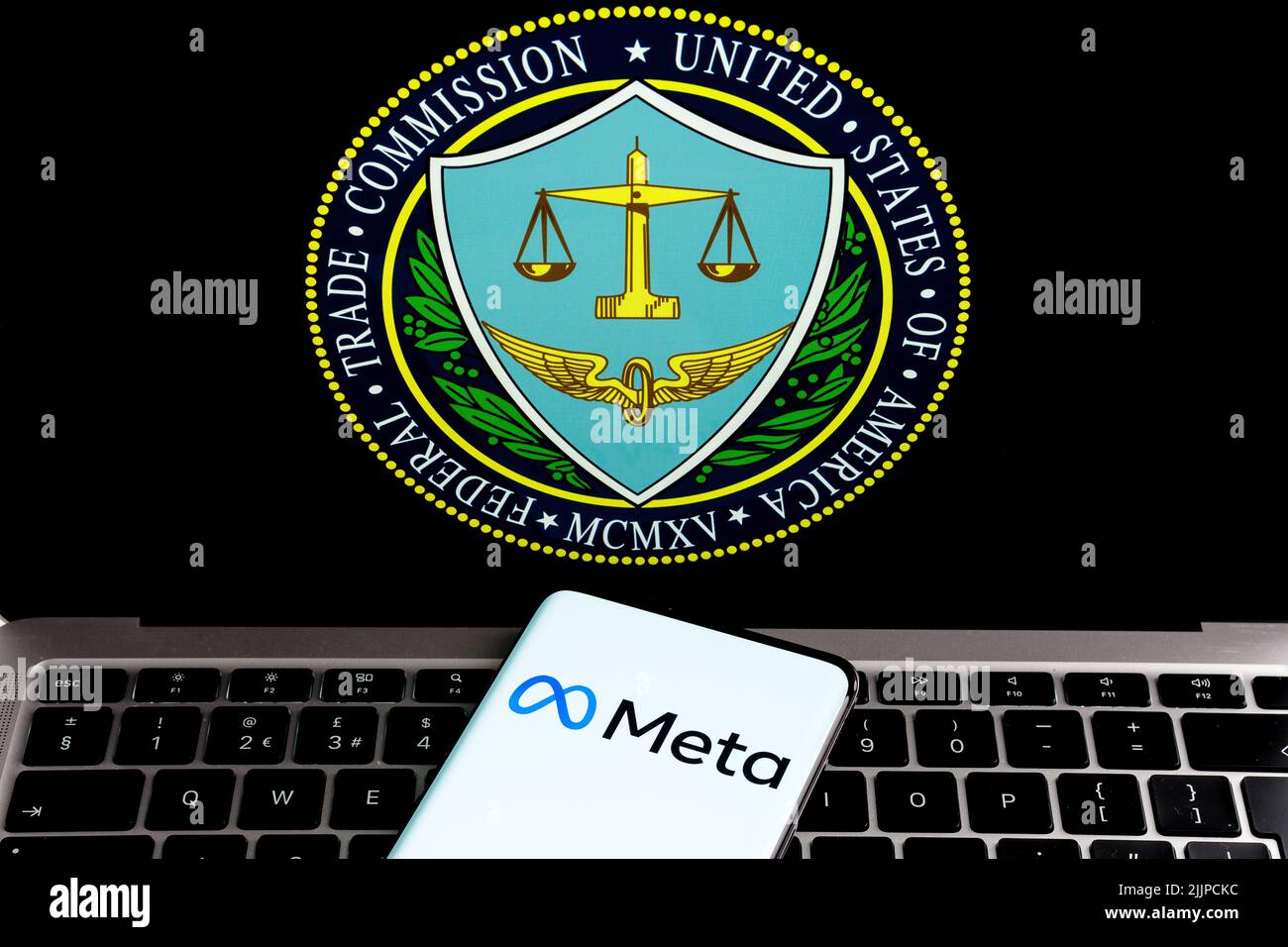 Meta company logo seen on smartphone and blurred FTC Federal Trade ...