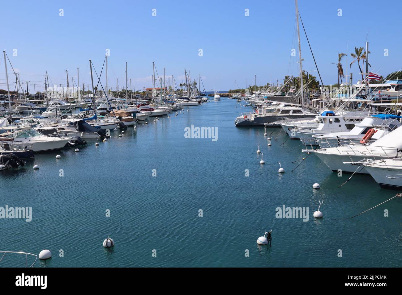 A scenic view of marina and harbor with fishing boats in Kailua-Kona ...