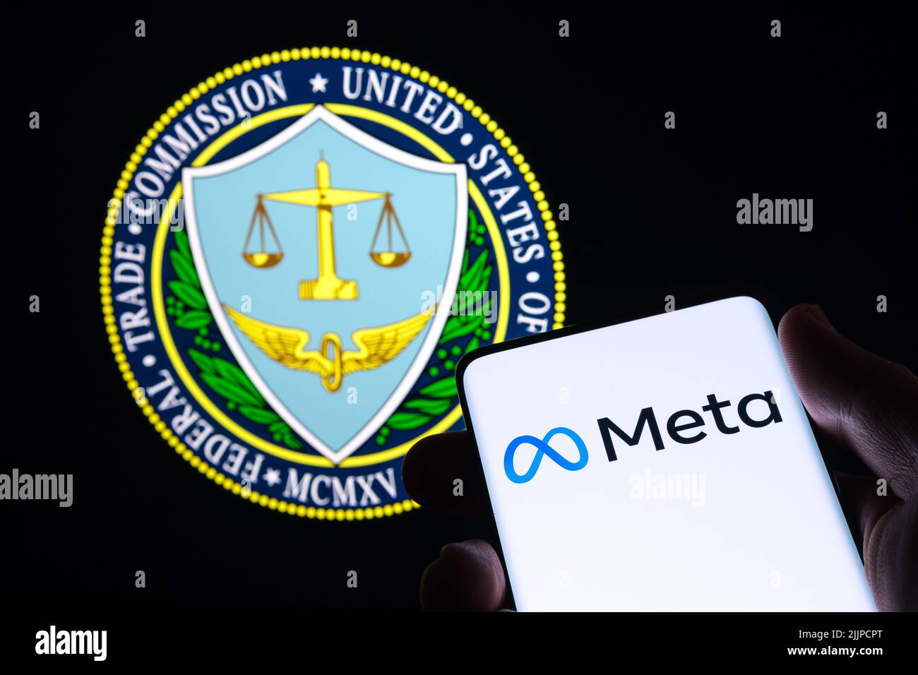 Meta company logo seen on smartphone and blurred FTC Federal Trade ...