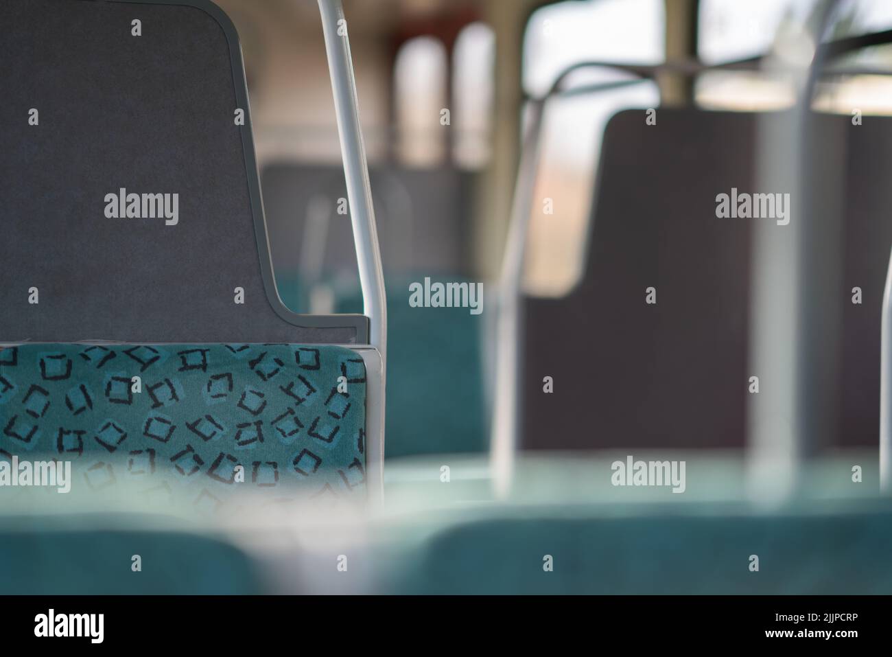 An inside view of a train with seats on a blurred background Stock ...