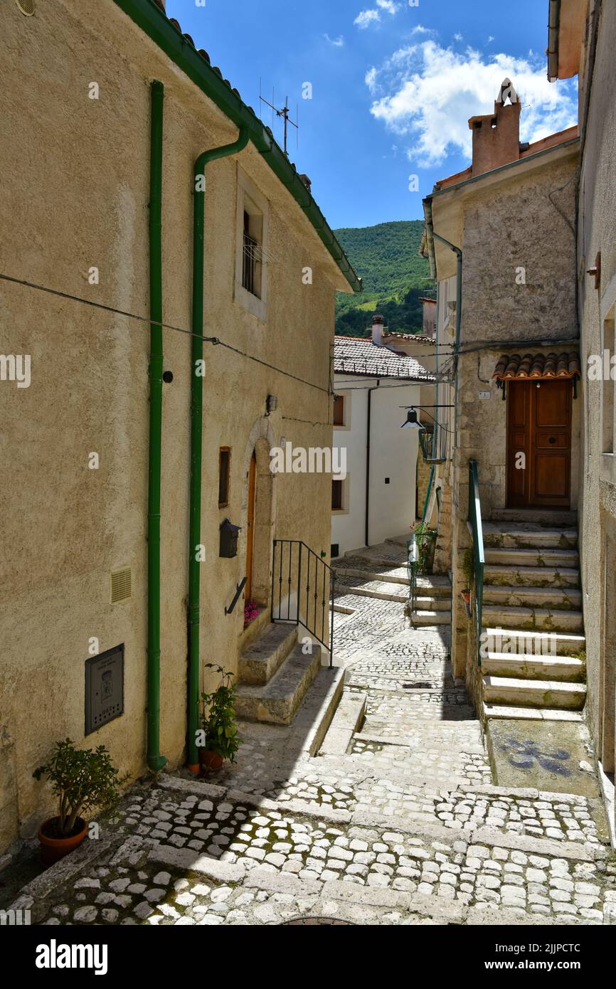 A vertical view of the narrow street among old stone houses of ...