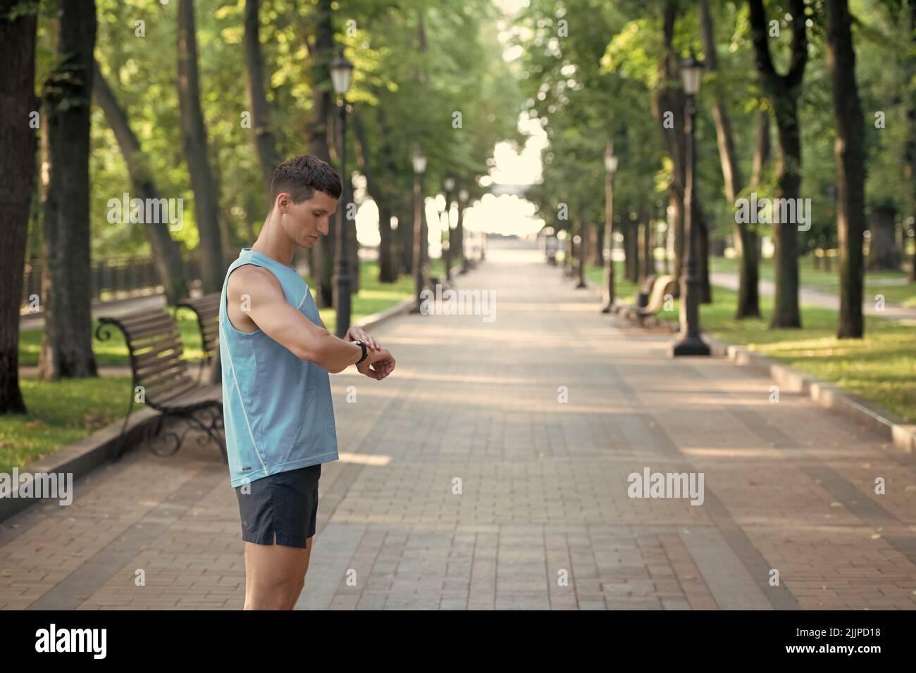 man checking time on smartwatch, copy space Stock Photo - Alamy