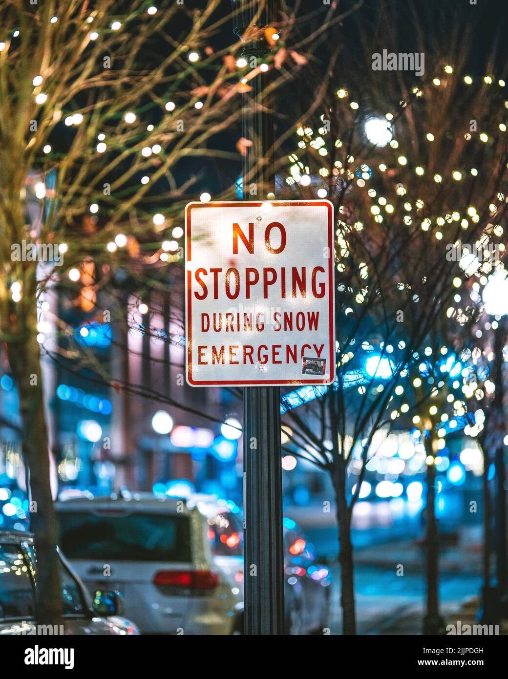 A closeup of a street sign text NO STOPPING DURING SNOW EMERGENCY in ...