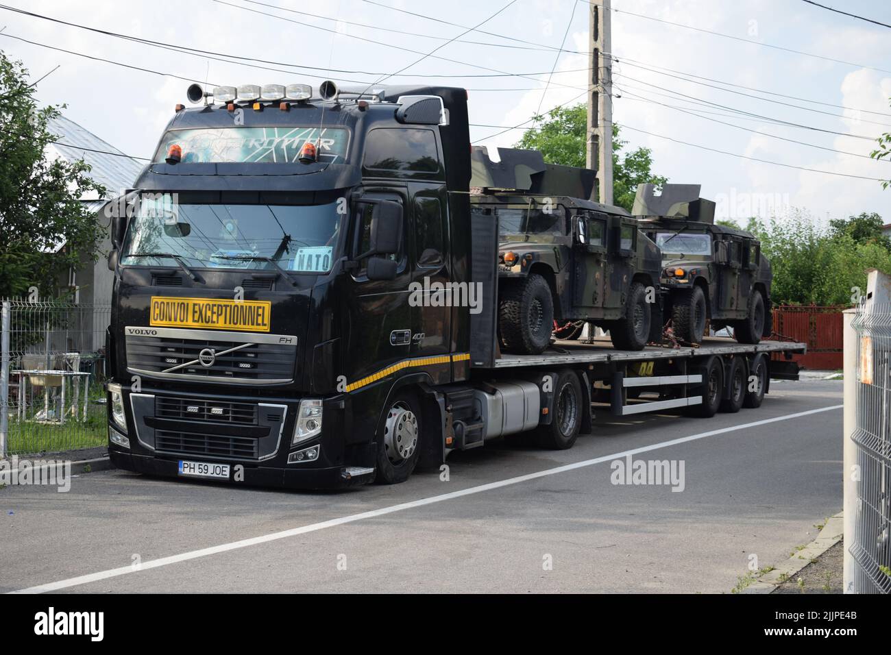 A parked truck with military vehicles in Romania Stock Photo - Alamy