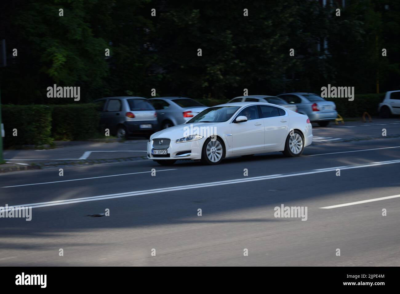 A white car on the street in Brasov, Romania, in summer Stock Photo - Alamy