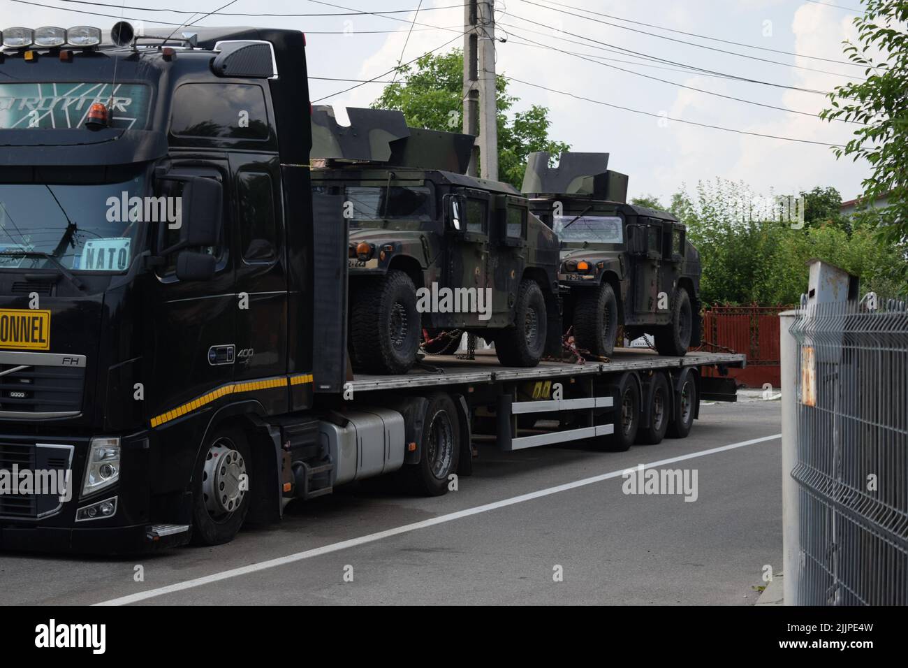 A parked truck with military vehicles in Romania Stock Photo - Alamy