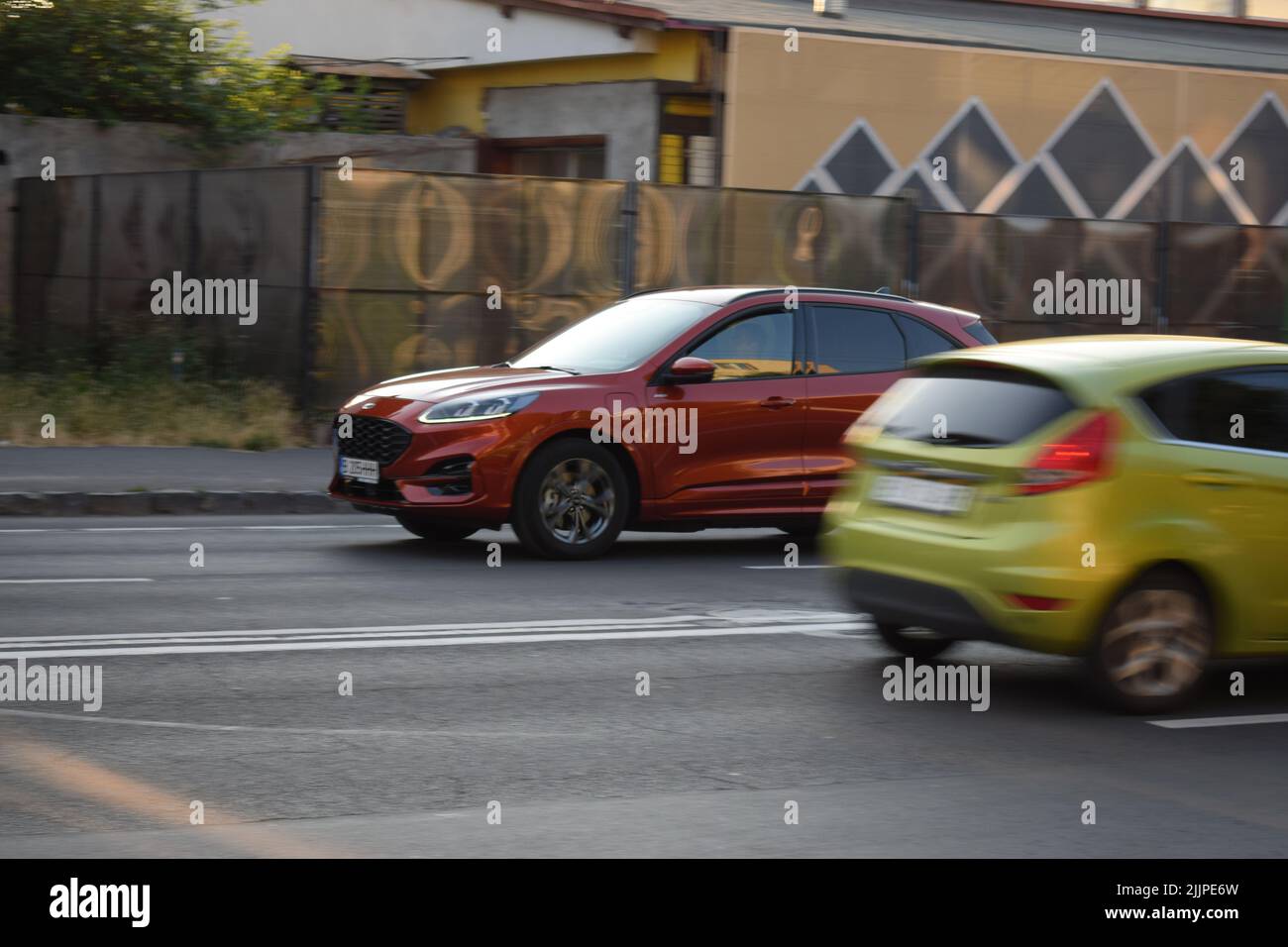 A red car on the street in Brasov, Romania, in summer Stock Photo - Alamy