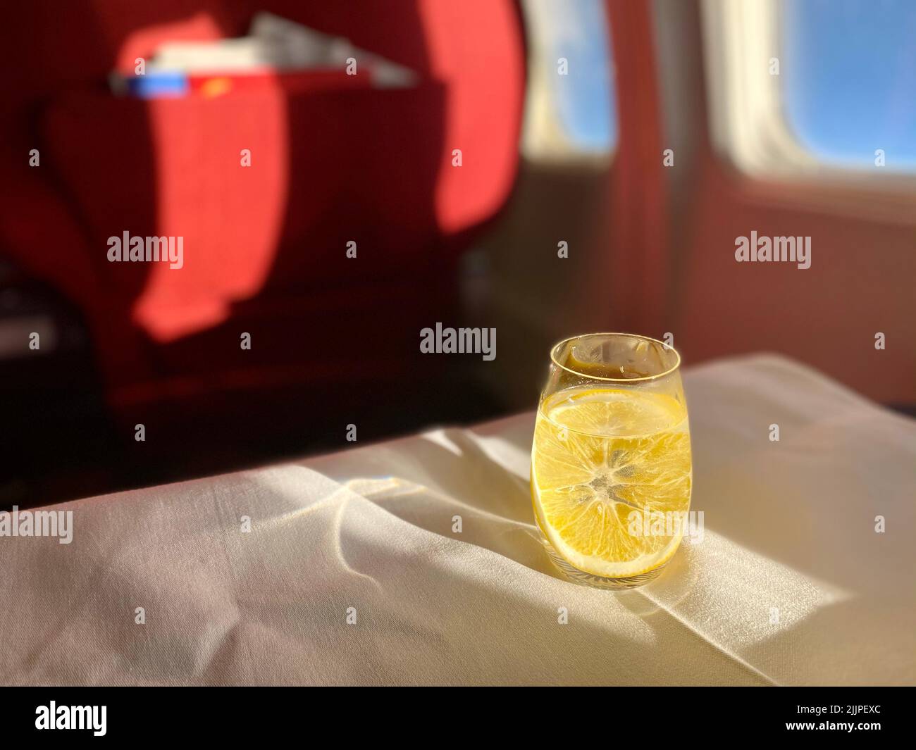 A shallow focus of a lemon glass cup in a First and business class ...