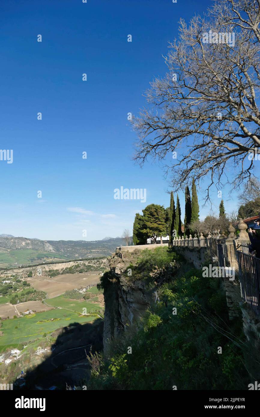 A vertical shot of the valley below the mountaintop city of Ronda in ...