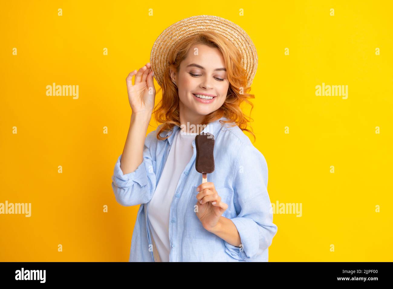 Portrait Of Beautiful Woman Eating Ice Cream On Orange Yellow