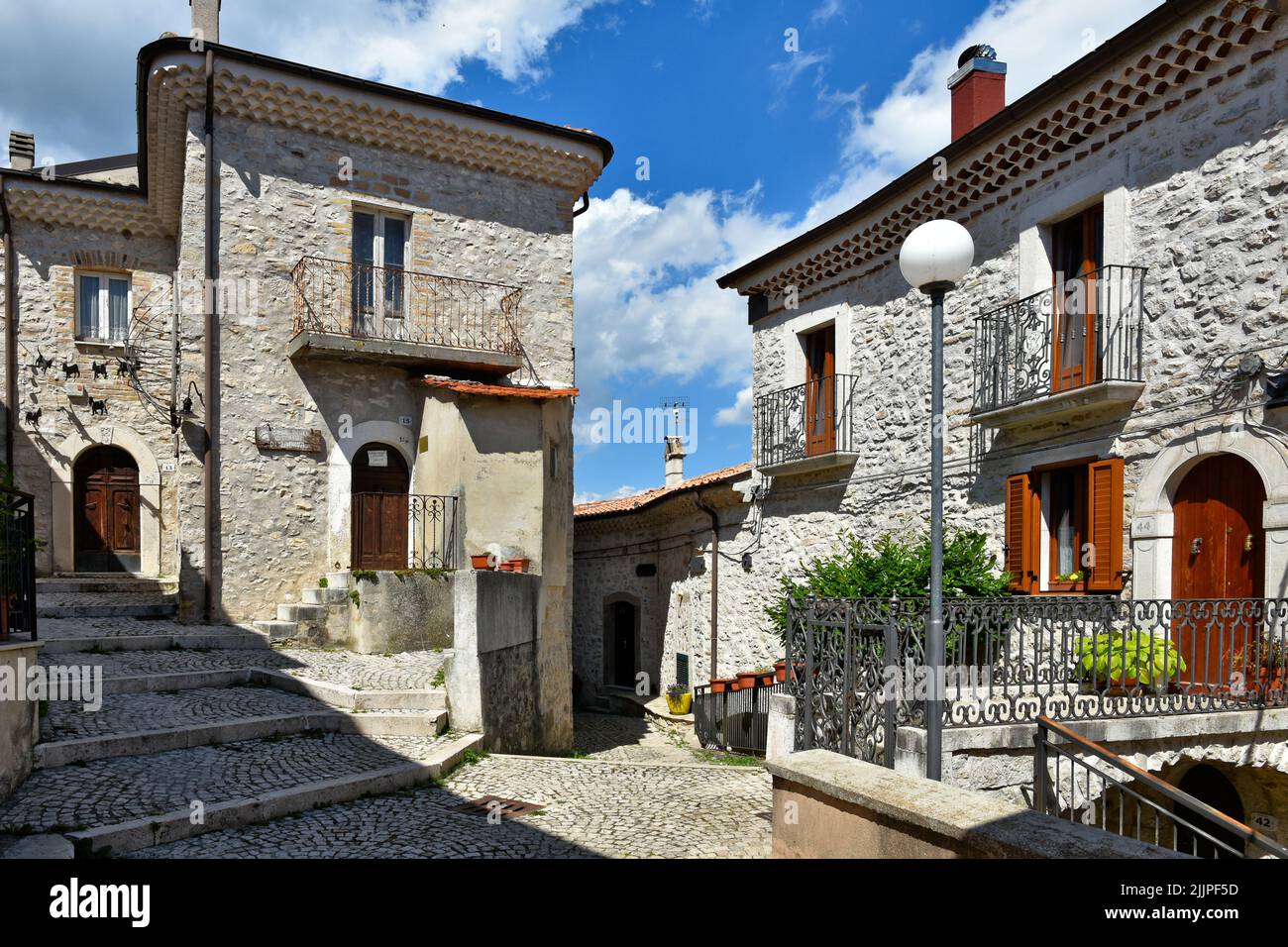 A narrow street among the old stone houses of Scontrone Stock Photo - Alamy