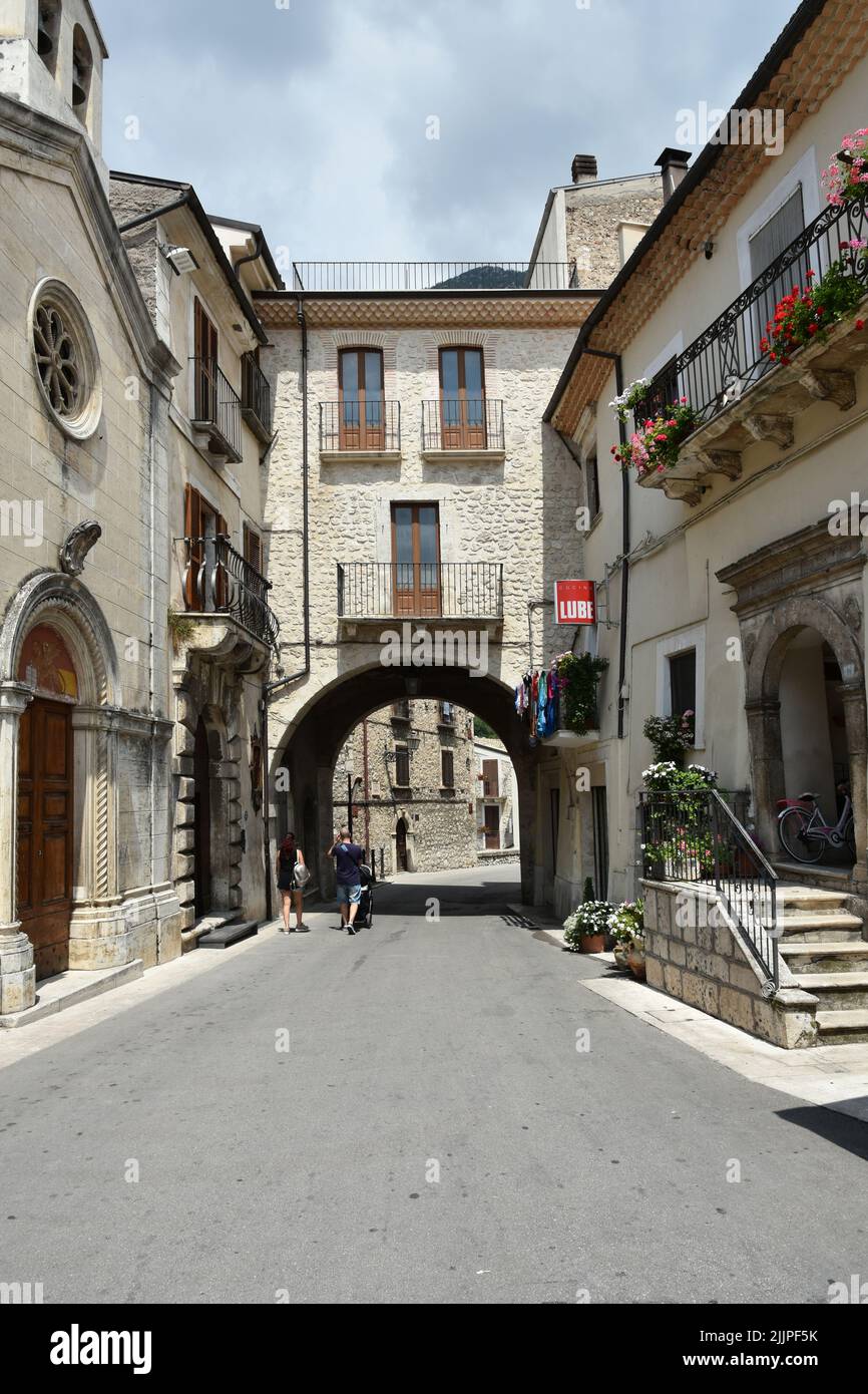 A view of narrow street among church and old stone buildings of ...