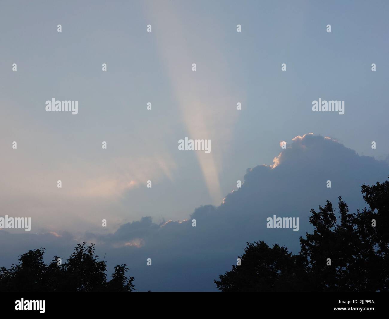 A scenic view of a blue sky with clouds and sun rays in Germany Stock ...