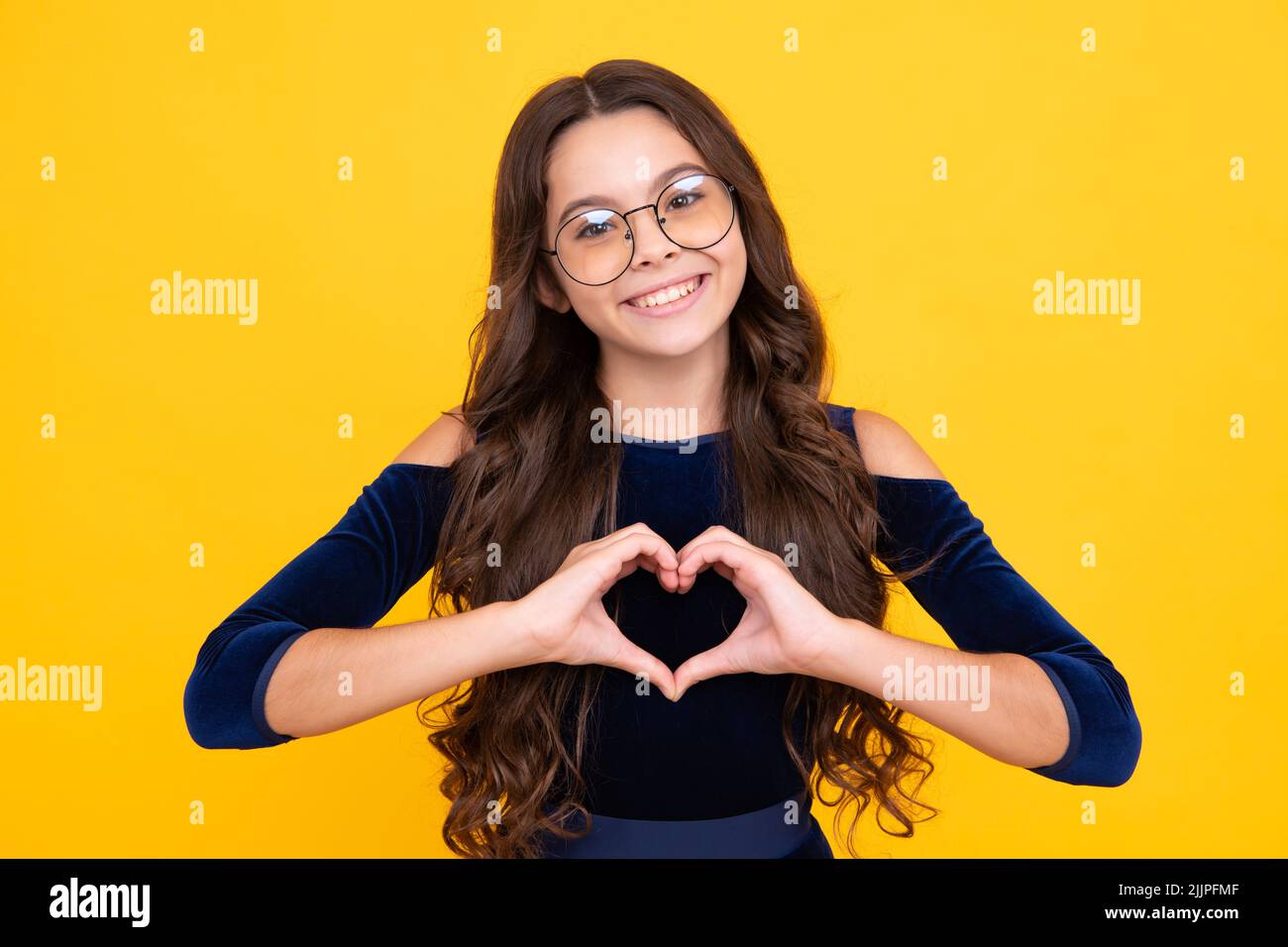 Child hands making sign heart by fingers. Lovely romantic teenage girl ...