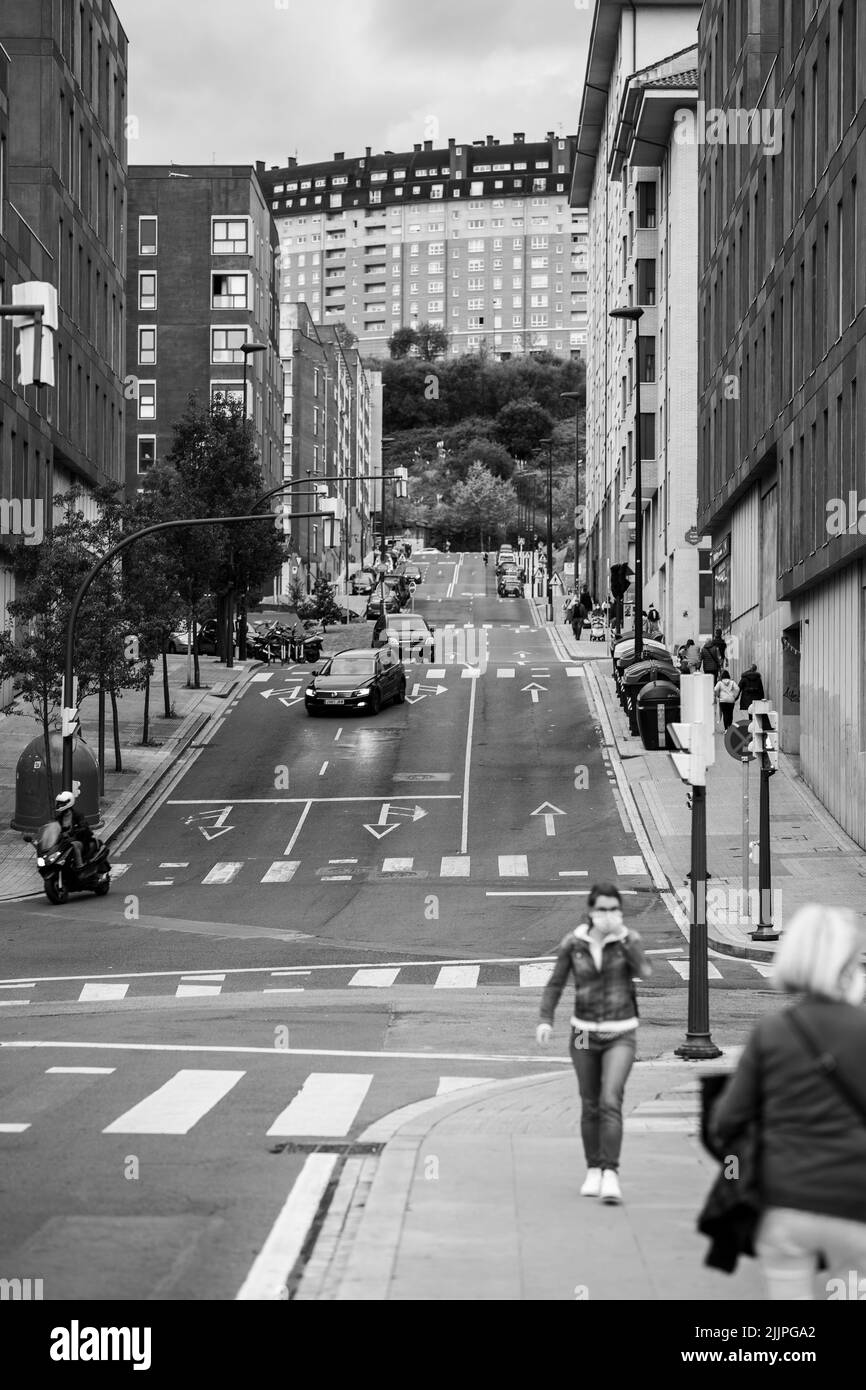 A grayscale shot of the busy street in the city of Bilbao in the Basque ...
