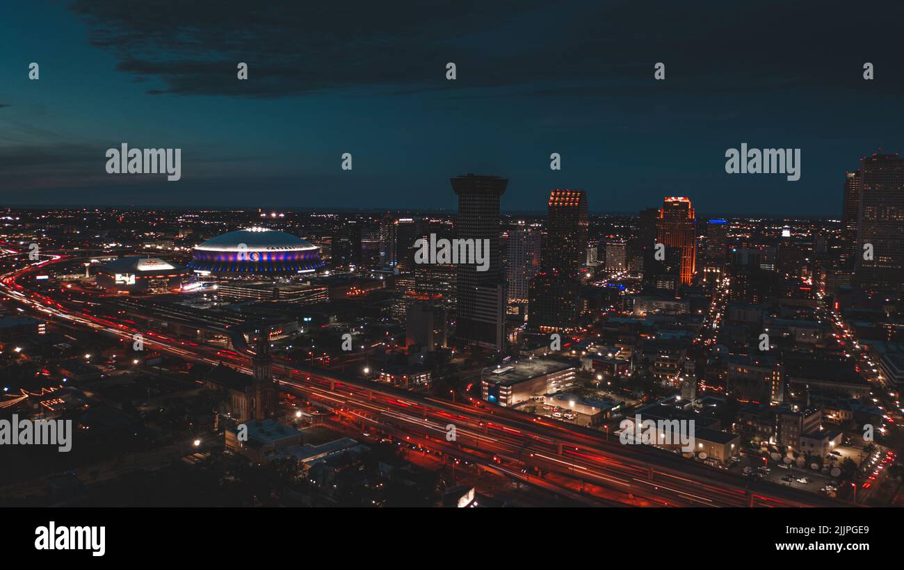 An aerial view of a beautiful city at night with lights shining under ...