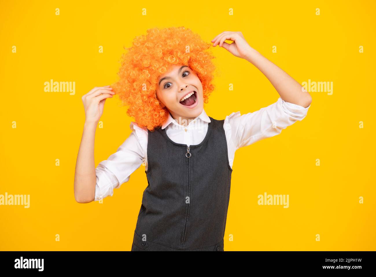 Funny kid with curly hair wig. Cute little girl with fancy hair. Child ...