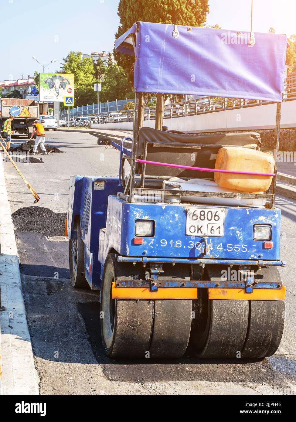 Russia, Sochi 03.07.2020. Road roller rolls asphalt. Road works are ...