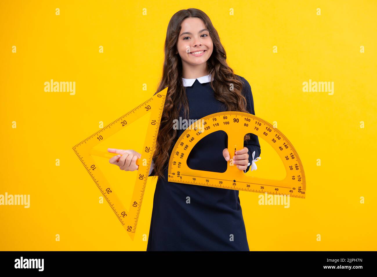 Schoolgirl in school uniform hold mathematics measure. Metric ...