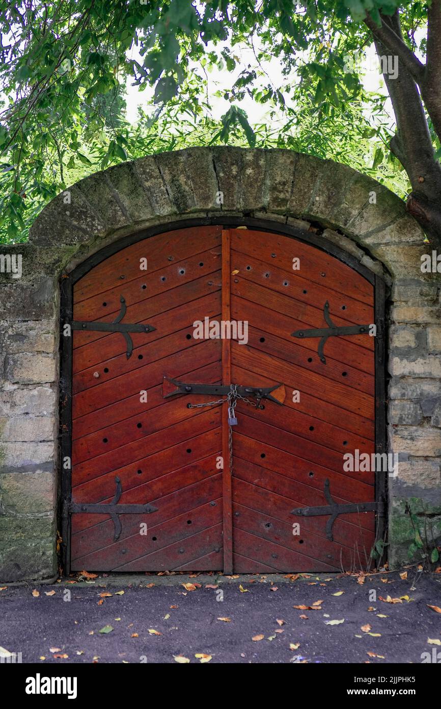 A vertical shot of a beautiful wooden gate to a Botanical Garden in ...