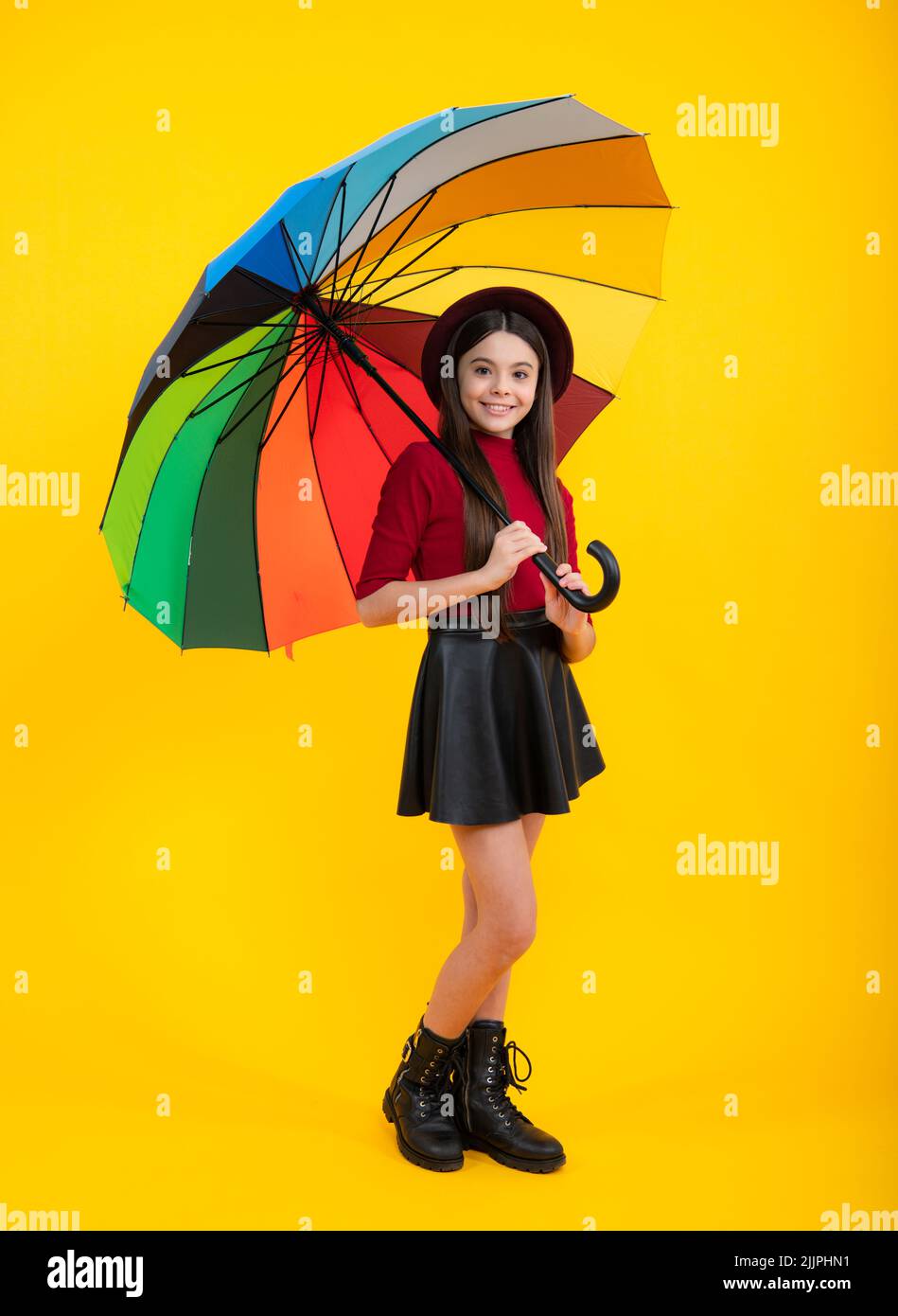 Fashion autumn kids weather. Child teenager girl with umbrella in skirt ...