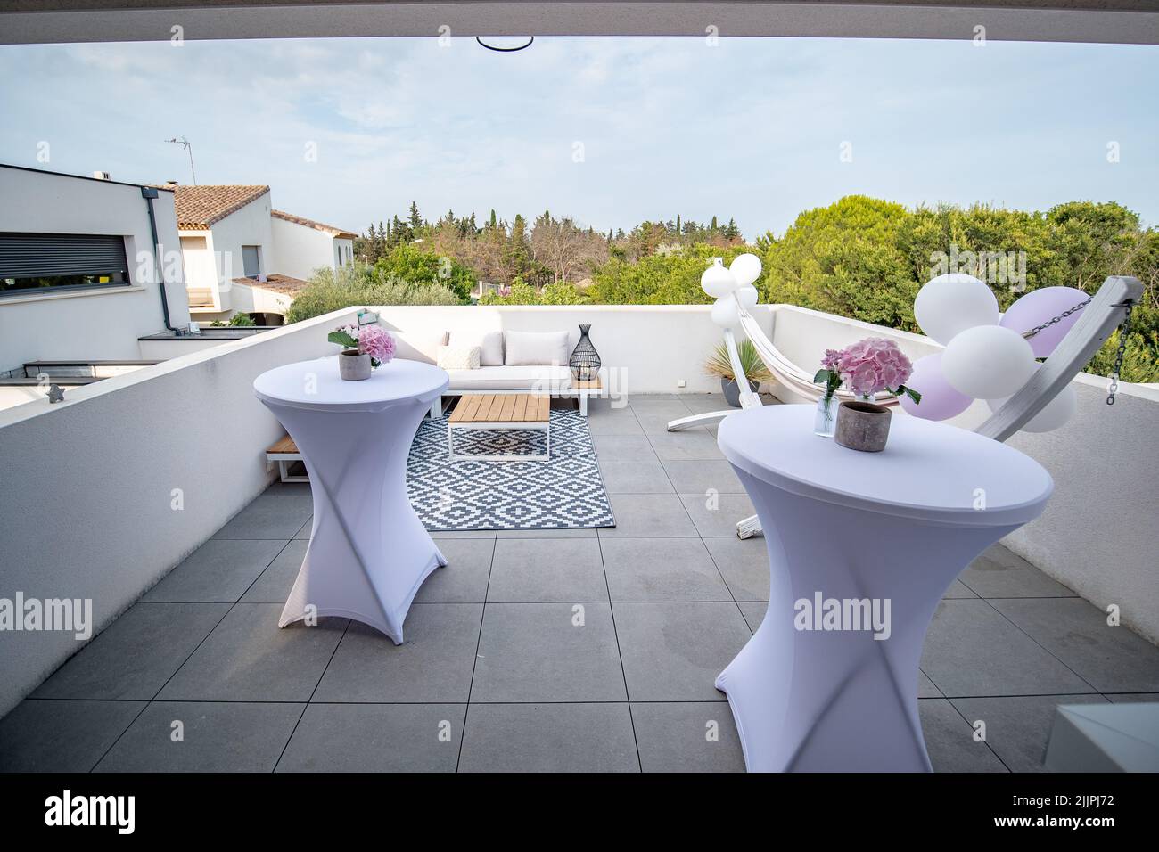 A modern balcony terrace with high tables set for a party Stock Photo ...