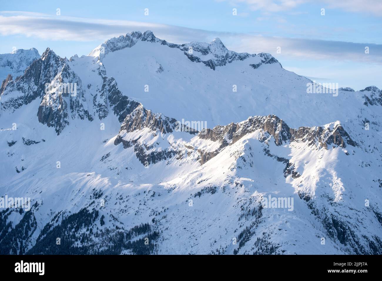 An aerial view of the beautiful Swiss alps covered in a thick layer of ...