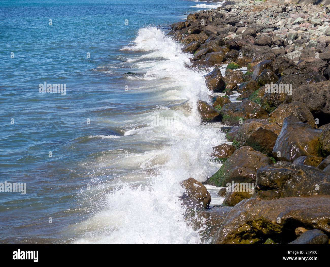 Surf. Waves crash on big rocks. Rocky coast and wave. Powerful ...