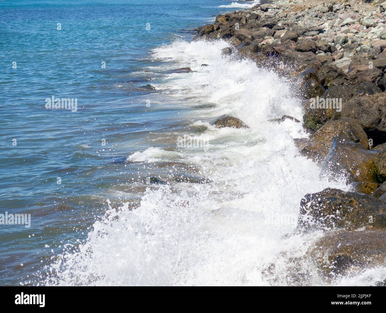 Surf. Waves crash on big rocks. Rocky coast and wave. Powerful ...