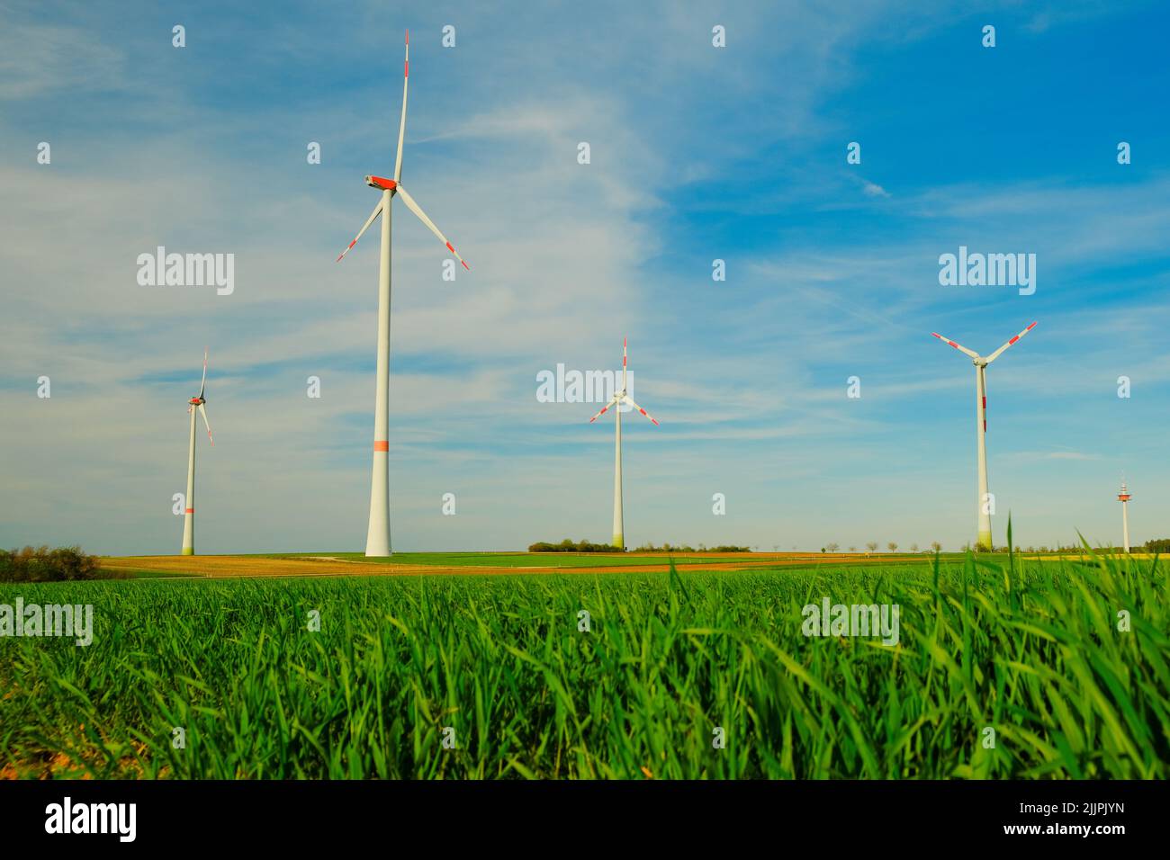 Wind renewable energy.Windmills in a field on a blue sky background ...