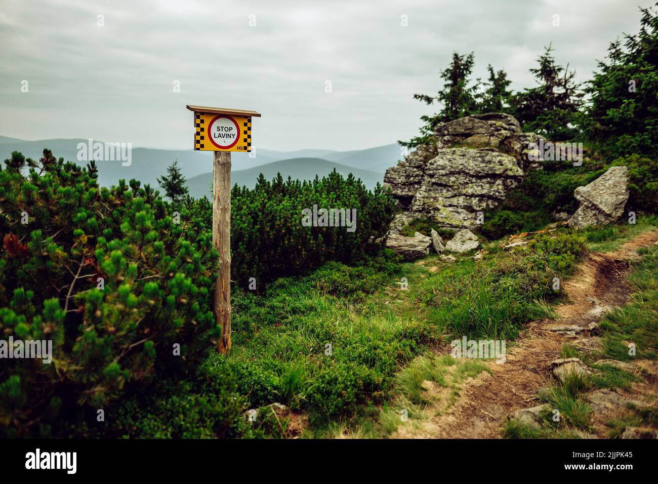 A stop sign in a green field next to a trail Stock Photo - Alamy