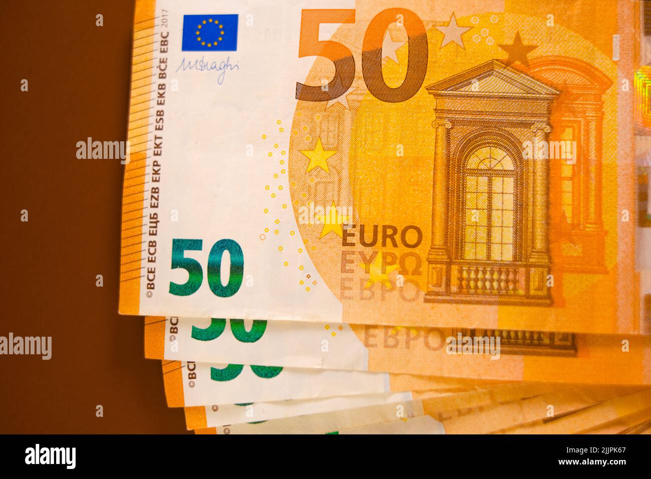 Euro money. Money background. euros banknotes pack set on a brown ...